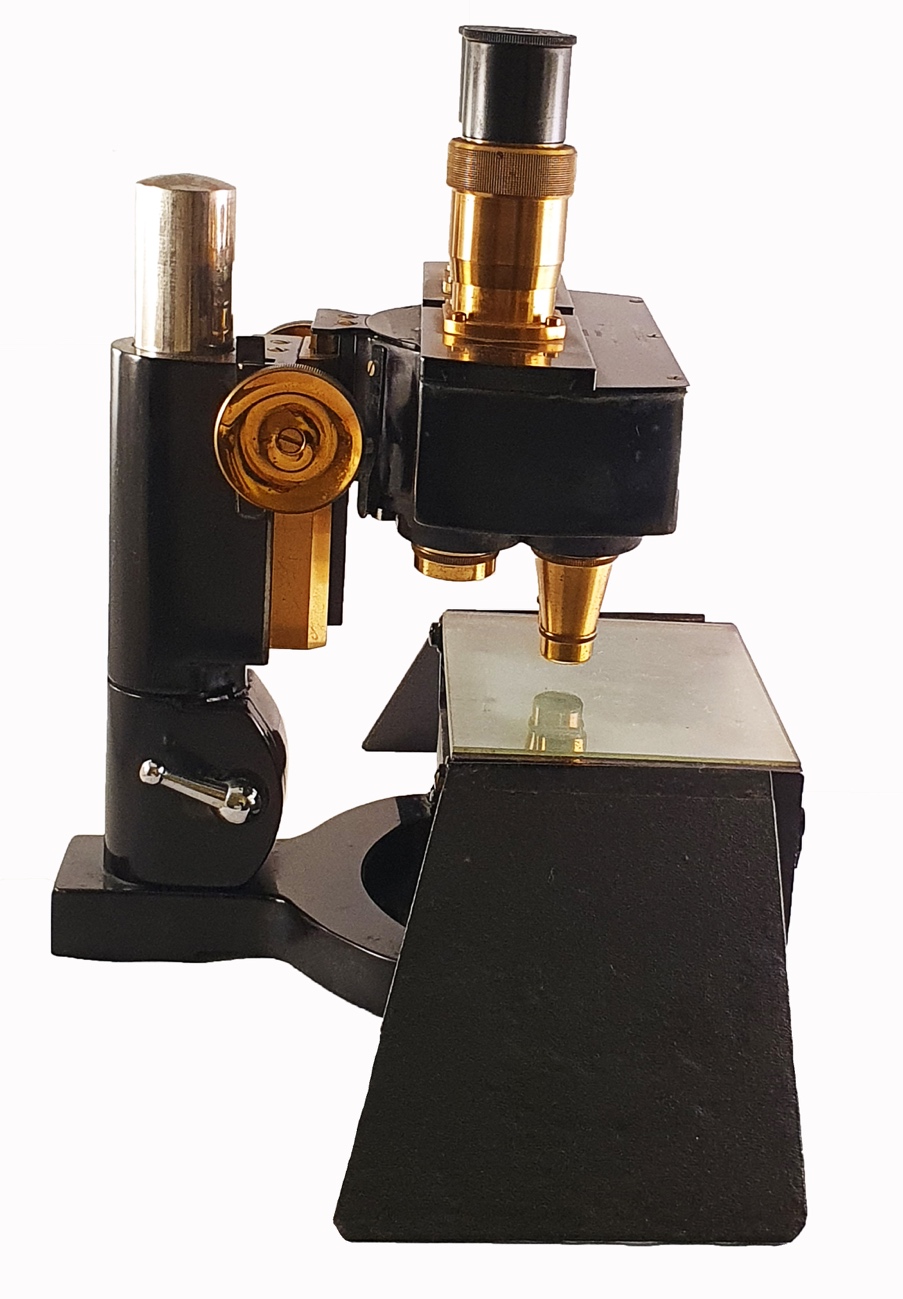 A black and gold microscopeDescription automatically generated with ...