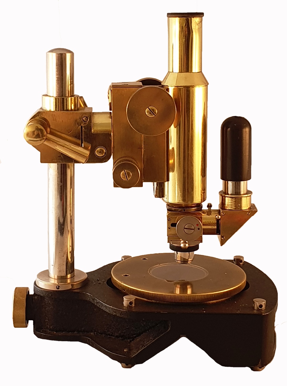 A close-up of a gold and black microscopeDescription automatically ...