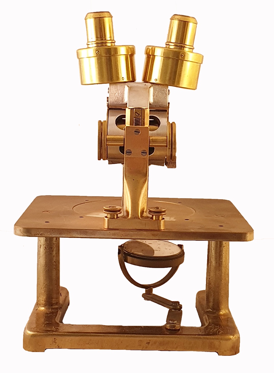 A close-up of a gold microscopeDescription automatically generated